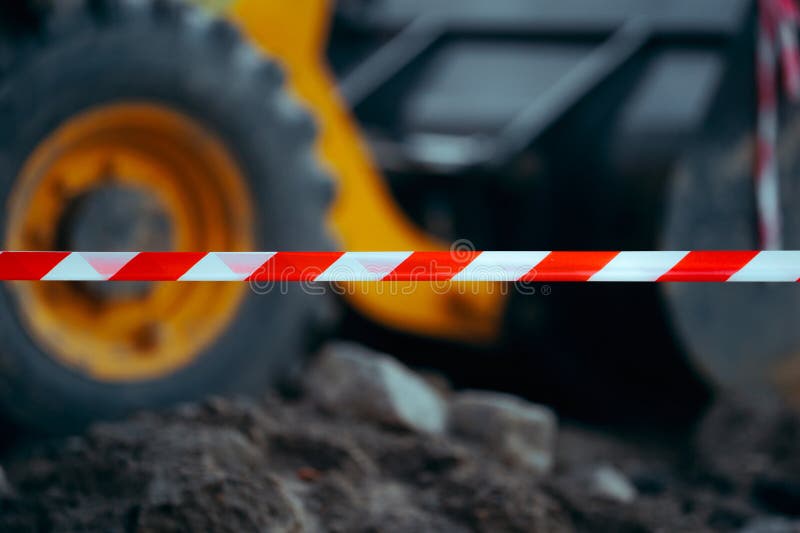 Excavator Behind a Warning Tape on a Construction Site Stock Image ...