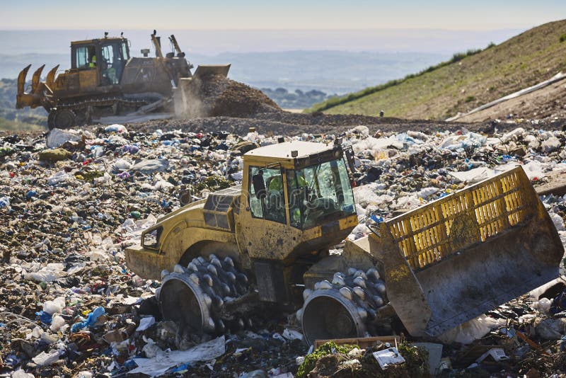 Heavy Machinery Shredding Garbage in an Open Air Landfill. Pollution ...