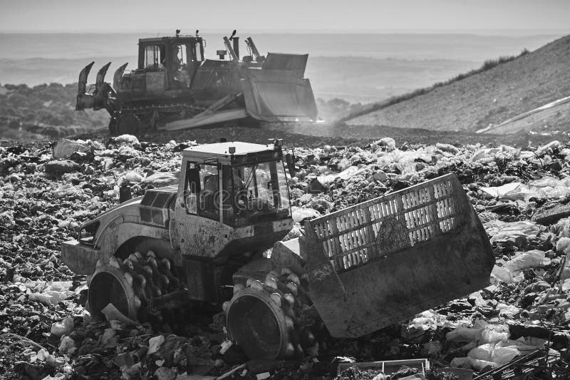 Heavy Machinery Shredding Garbage in an Open Air Landfill. Pollution ...