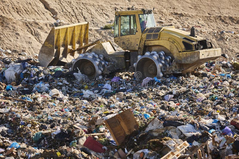 Heavy Machinery Shredding Garbage in an Open Air Landfill. Pollution ...