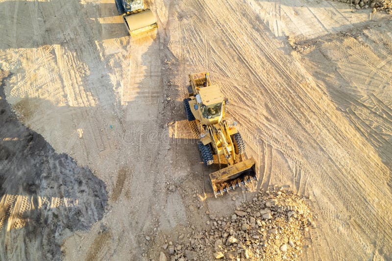 Heavy Machinery at Work during a Construction Project, Moving Earth and ...