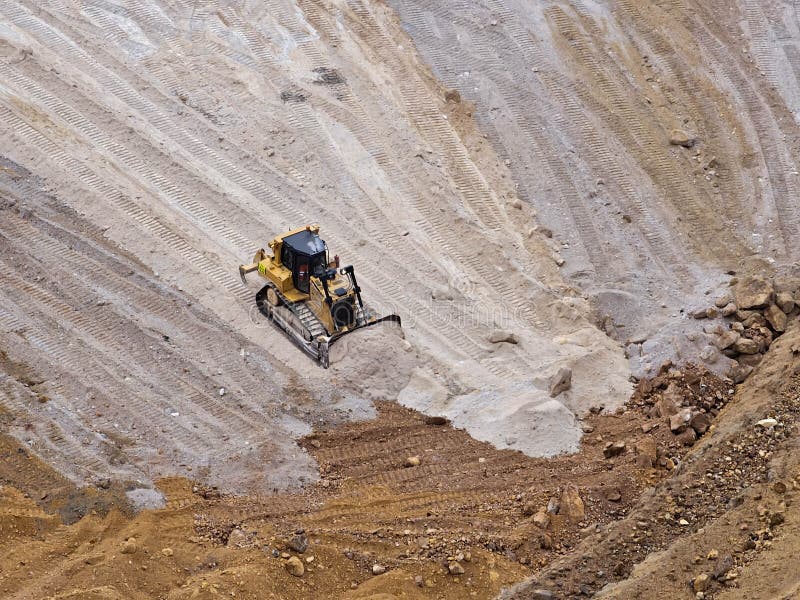 Heavy Machinery Working at the Bottom of an Open Pit Mine on a Day with ...