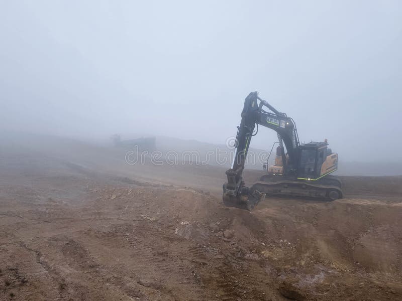 Heavy Machinery Working at the Bottom of an Open Pit Mine on a Day with ...