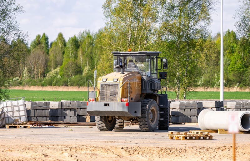 Heavy Orange Wheeled Loader Transporting Pallet with Concrete Blocks ...