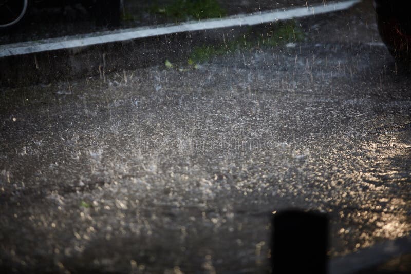 Heavy rain drops on road. stock image. Image of rain - 113053579
