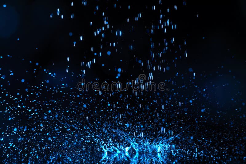 Rain Falling Down on Ground Against Dark Background, Toned in Blue ...