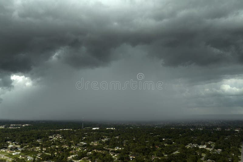 Heavy Rain Falling Down from Stormy Clouds Over Rural Florida Suburbs. Thunderstorm on Dark Sky ...