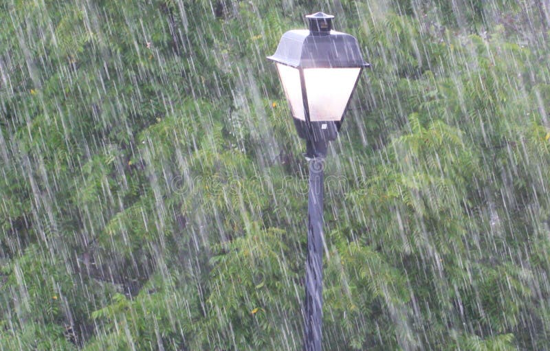 Heavy rain and lamp post stock image. Image of lamp - 253366399