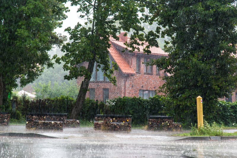 Heavy rain outdoors stock photo. Image of outdoors, building - 346987764