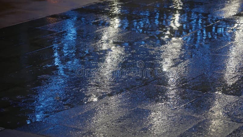 Heavy Rain Pouring into Small Puddle on the Ground with the Reflection ...