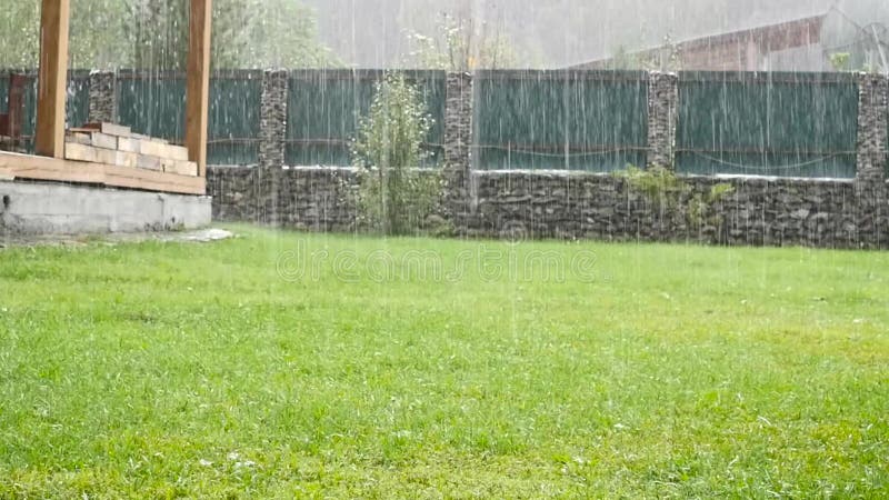 Heavy Rain Shower in Backyard at Unfinished House. Slow Motion Stock ...