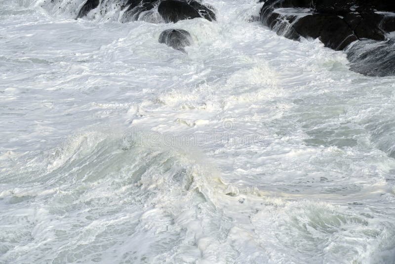 Heavy seas crash on rocks stock image. Image of tide - 194318825