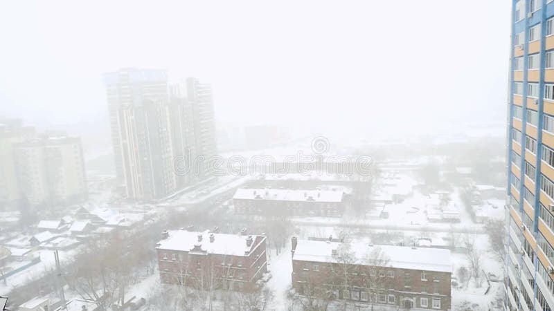 Heavy Snowfall in the City in Slowmotion. Streets, Houses and Machine ...