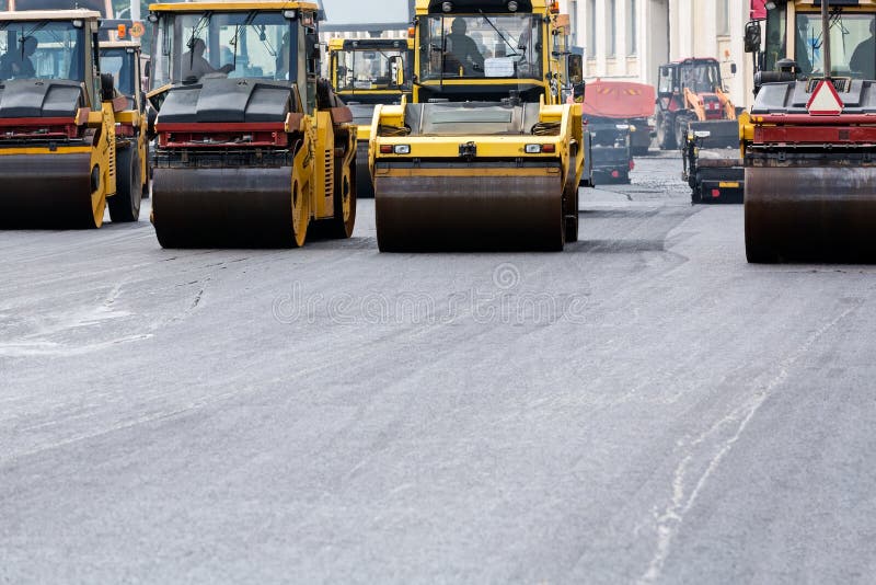 Road rollers paving a road stock image. Image of roll - 42647823