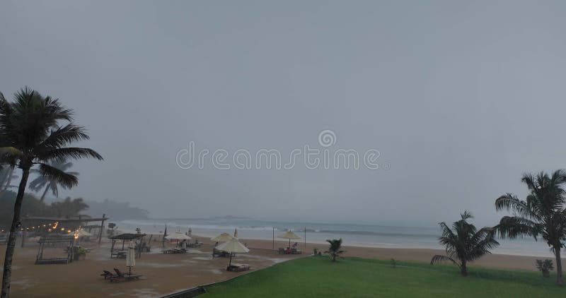 Heavy Tropical Rain Falling on an Empty Sandy Beach with Waves in the ...