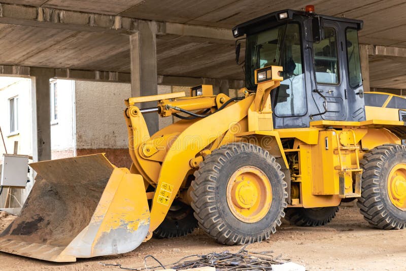 Heavy Wheel Loader with a Bucket at a Construction Site. Close-up ...