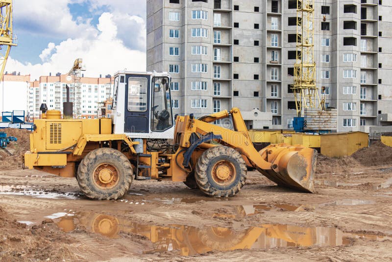 Heavy Wheel Loader with a Bucket at a Construction Site. Equipment for ...