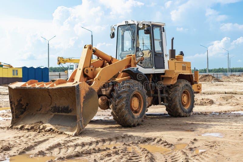 Heavy Wheel Loader with a Bucket at a Construction Site. Equipment for ...