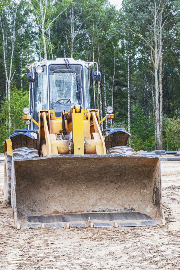 Heavy Wheel Loader with a Bucket at a Construction Site. Equipment for ...