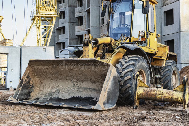 Heavy Wheel Loader with a Bucket at a Construction Site. Equipment for ...