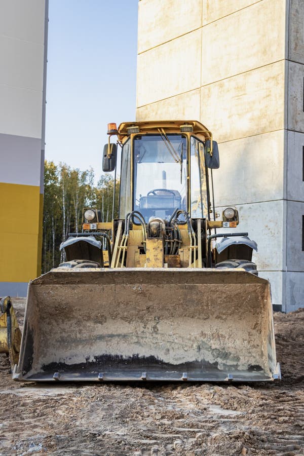 Heavy Wheel Loader with a Bucket at a Construction Site. Equipment for ...
