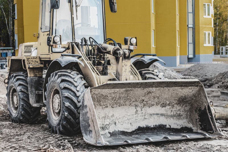 Heavy Wheel Loader with a Bucket at a Construction Site. Equipment for ...
