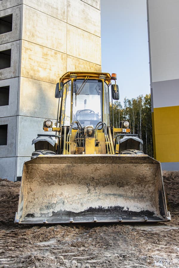 Heavy Wheel Loader with a Bucket at a Construction Site. Equipment for ...