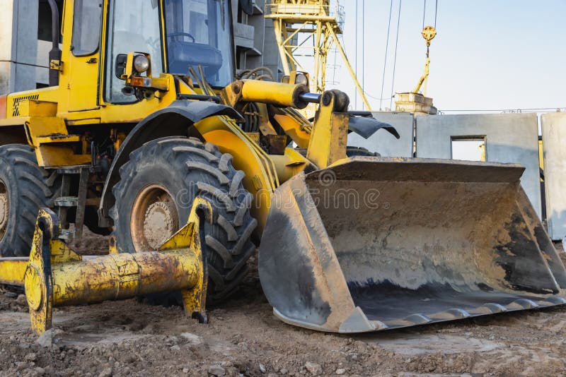 Heavy Wheel Loader with a Bucket at a Construction Site. Equipment for ...