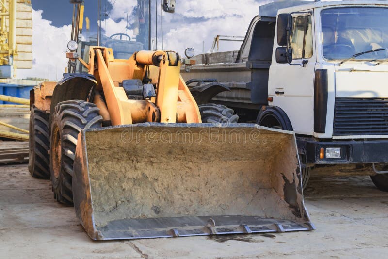 Heavy Wheel Loader with a Bucket at a Construction Site. Equipment for ...