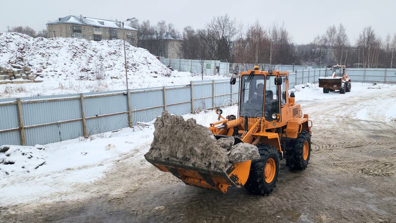 Heavy Wheeled Excavator Loading Snow Stock Photos - Free & Royalty-Free ...