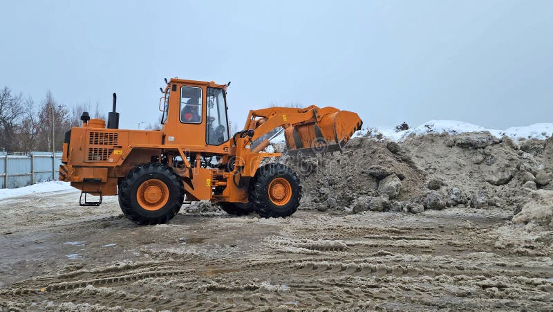 A Heavy-wheeled Excavator is Loading Snow Stock Photo - Image of ...