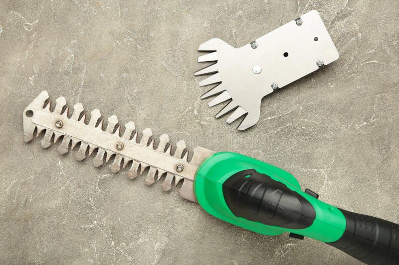 Hedge Trimmer New Cordless Hedge Trimmer on Grey Concrete Background ...