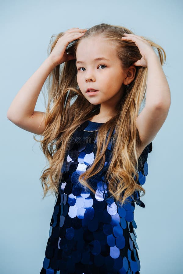 Heerlijk Meisje in Een Blauwe Jurk Die Voor Haar Rommelige Haar Zorgt ... Heerlijk Meisje in Een Blauwe Jurk Die Voor Haar Rommelige Haar Zorgt ...