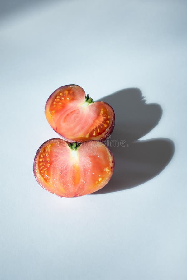 An Heirloom Tomato Cut in Half with One Half on Top of the Other Stock ...