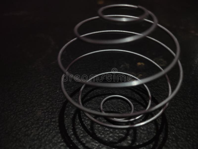 Helical spring shaker dark stock photo. Image of lighting - 245993094