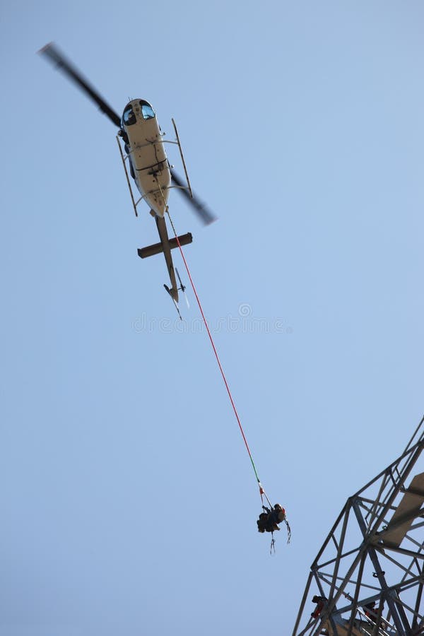 Helicopter Airlifting Workmen from Power Line Stock Image - Image of ...
