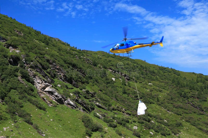 Helicopter with bag stock photo. Image of height, summer - 27696404