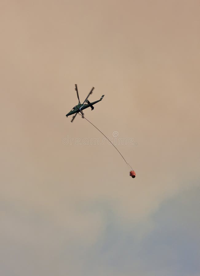 Helicopter Carrying Helibucket Stock Image - Image of carrying, cloud ...