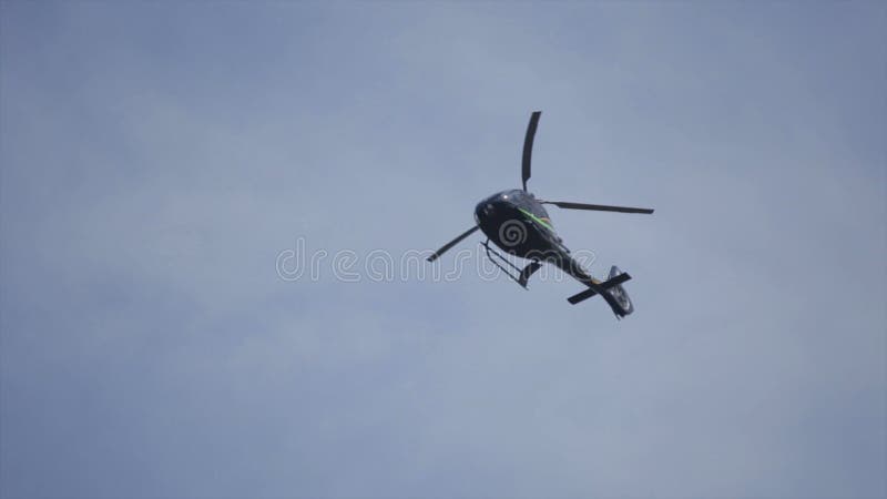 Helicopter in the Cloudy Sky with Lightning. Helicopter from Below ...