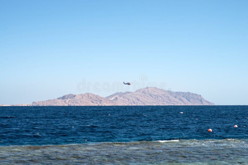 Helicopter Flies Over the Sea Stock Photo - Image of color, scenic ...