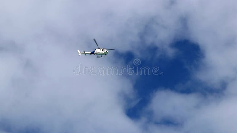 Helicopter Flying in Bright Sunny Blue Sky with White Clouds Stock ...
