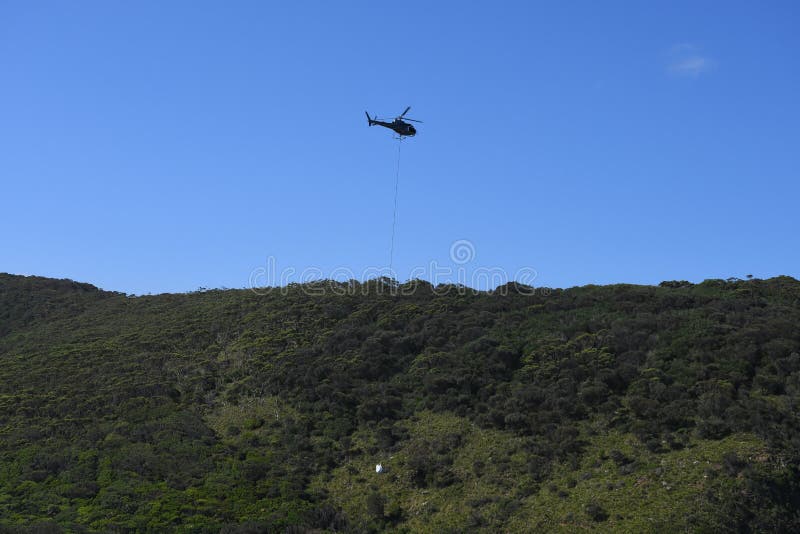Helicopter Flying Over Forested Mountains in Figure 8 Pool Area of ...