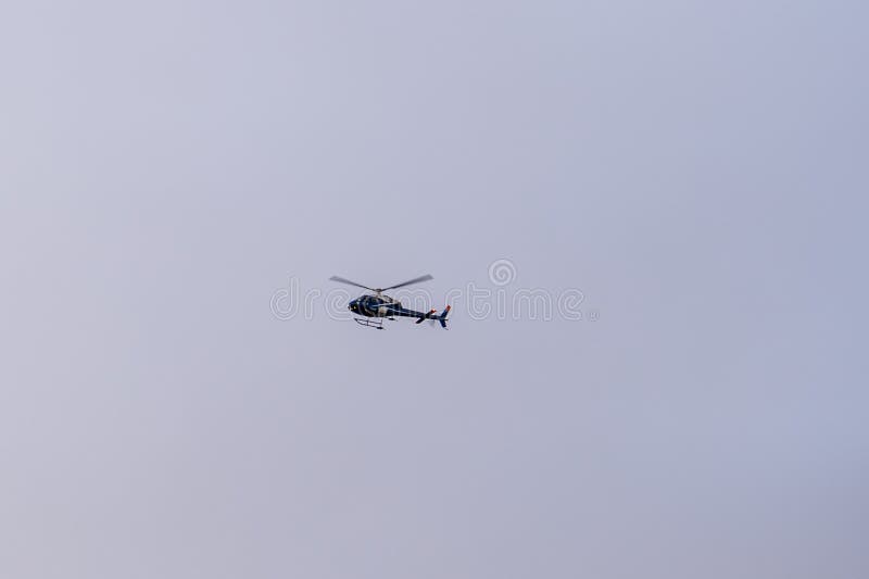 A Helicopter is Flying in the Sky. a Helicopter during Flight Stock ...