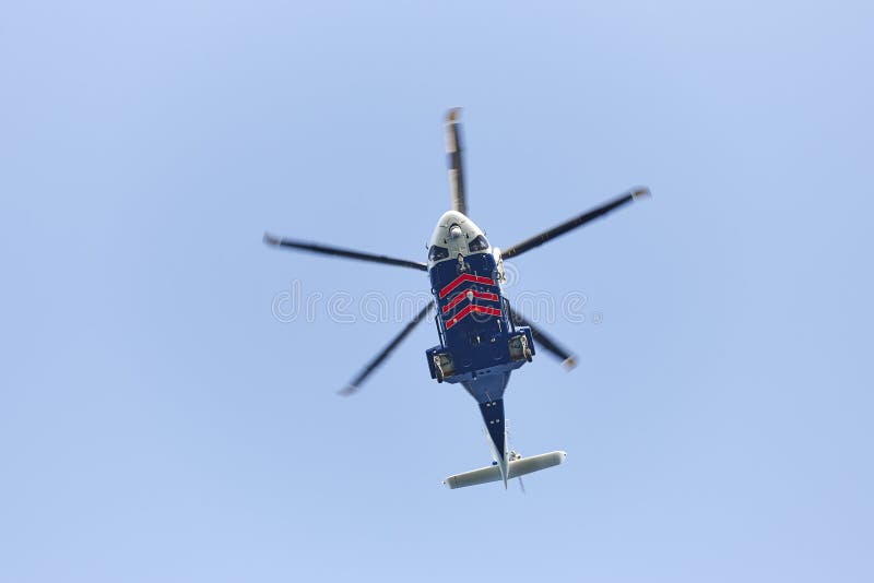 Helicopter Flying Under a Blue Sky from Below. Transport Stock Photo ...