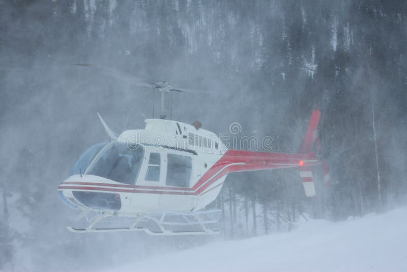 The Helicopter Landed in the Mountains in Winter, Raising a Cloud of ...