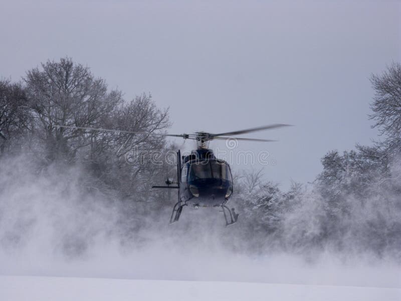 A Helicopter in the Snow Covered Landscape and Mountain in the Alps ...