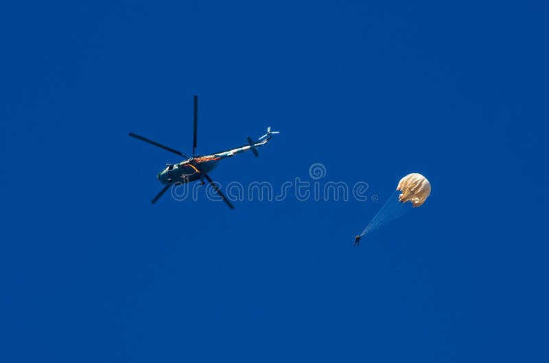 Helicopter and the Parachutist Stock Photo - Image of dome, operation ...
