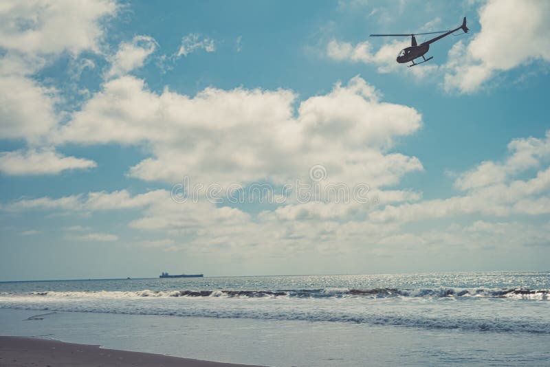 Helicopter Patrols Over the Ocean Beach Stock Image - Image of coast ...