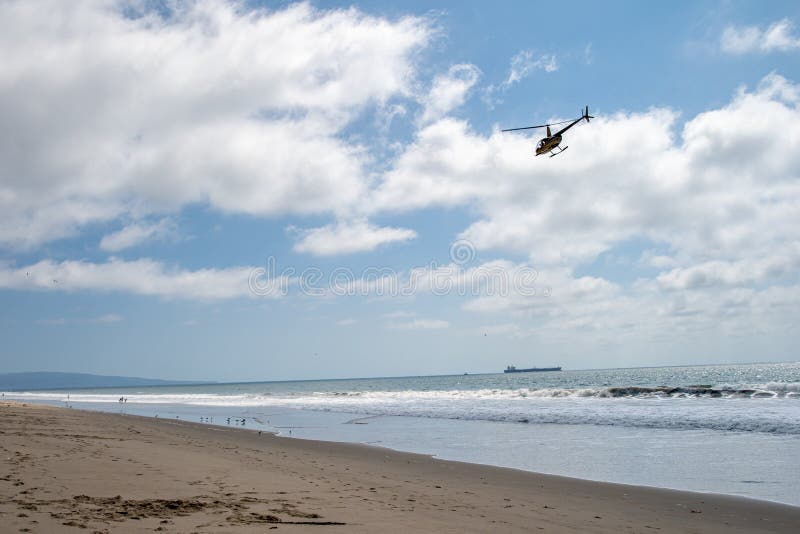 Helicopter Patrols Over the Ocean Beach Stock Photo - Image of flight ...