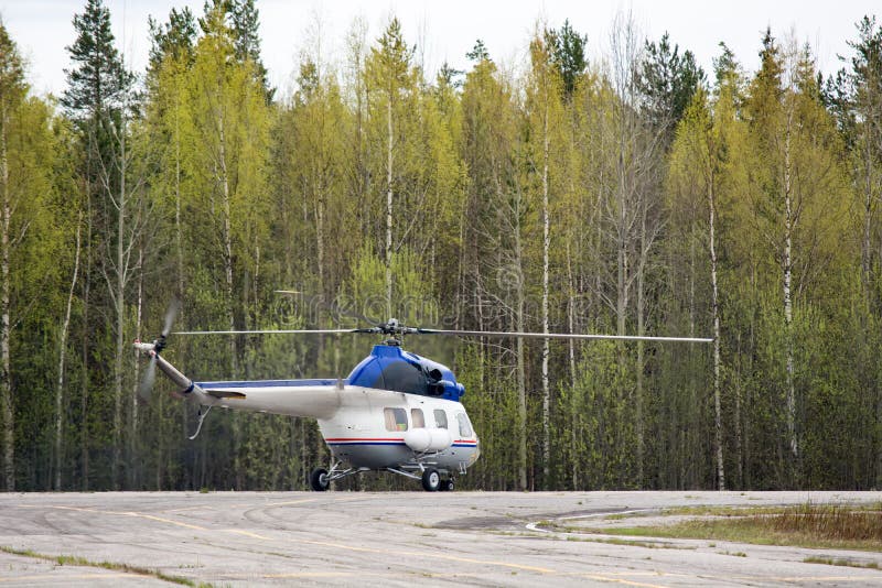 Helicopter Stands on the Runway Stock Photo - Image of blue, field ...
